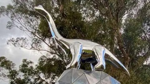 Title: "Boom Boom: The Controversial Dinosaur Sculpture Stirring ...